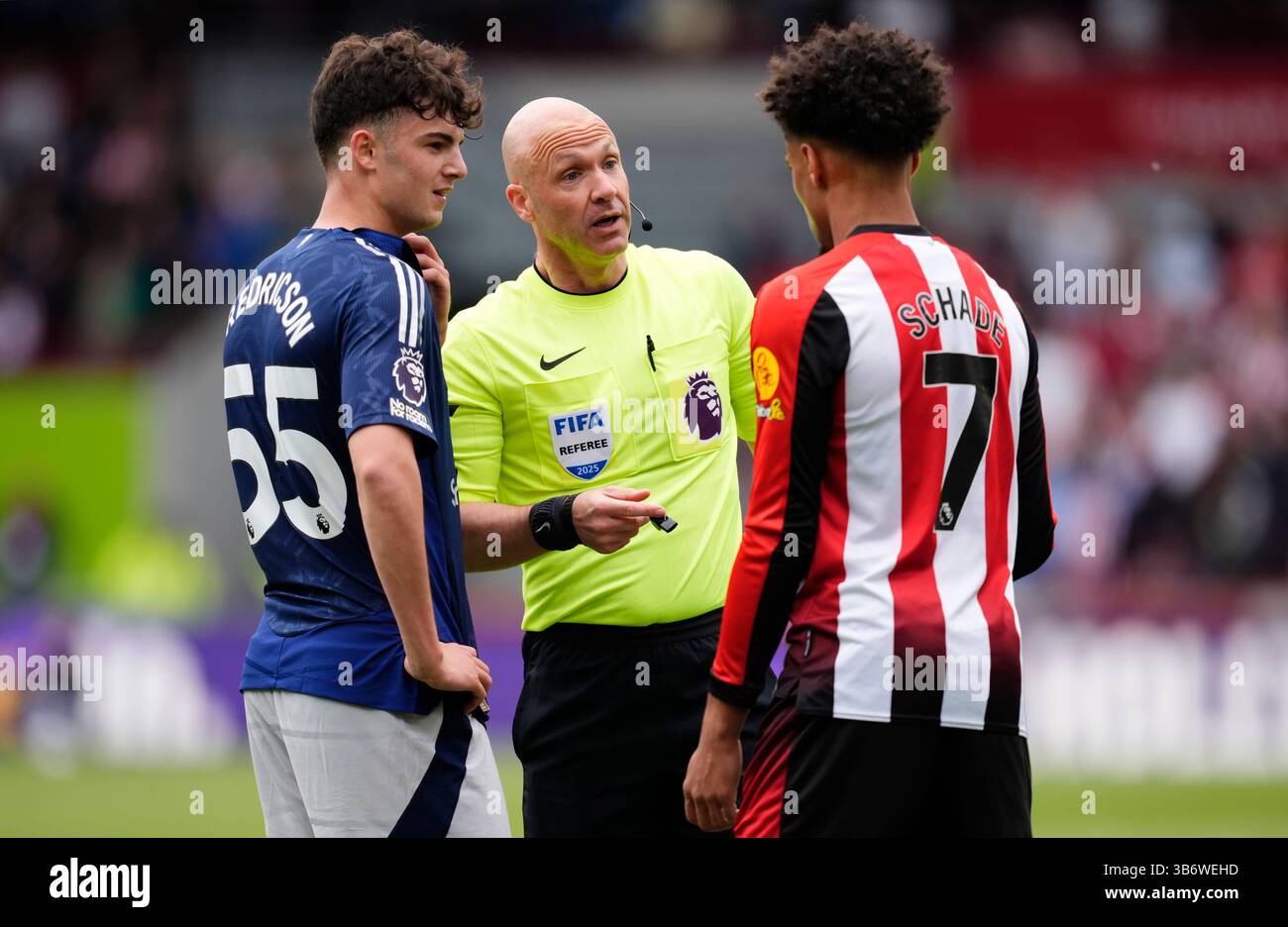 Referee Anthony Taylor speaks with Manchester United's Tyler Fredricson (left) and Brentford's ...