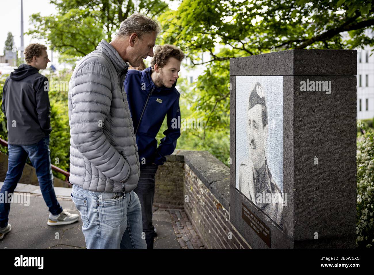 ARNHEM - People look at the new plaque on the monument at the John ...
