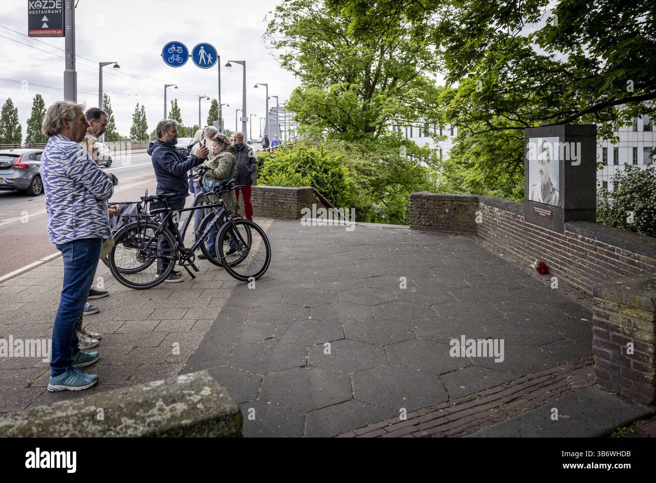 ARNHEM - People look at the new plaque on the monument at the John ...