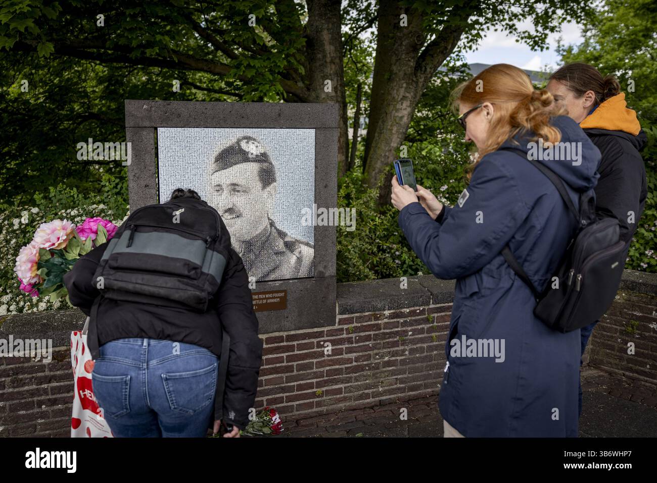 ARNHEM - People look at the new plaque on the monument at the John ...