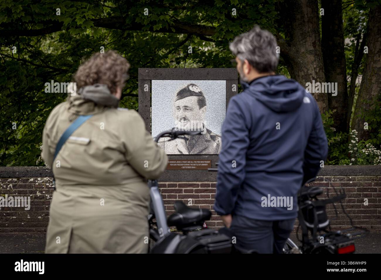 ARNHEM - People look at the new plaque on the monument at the John ...