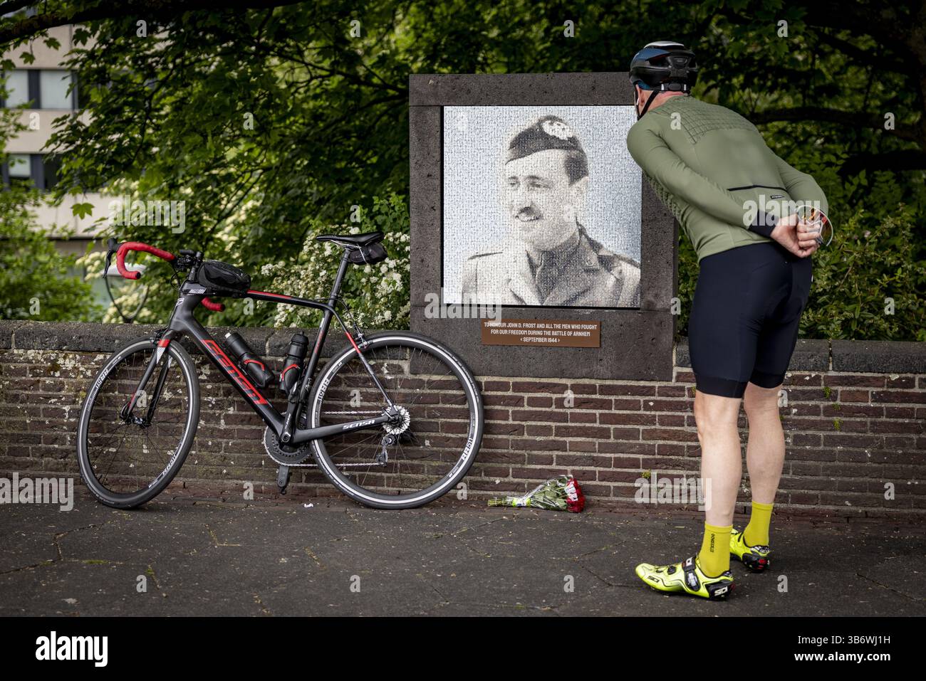 ARNHEM - People look at the new plaque on the monument at the John ...