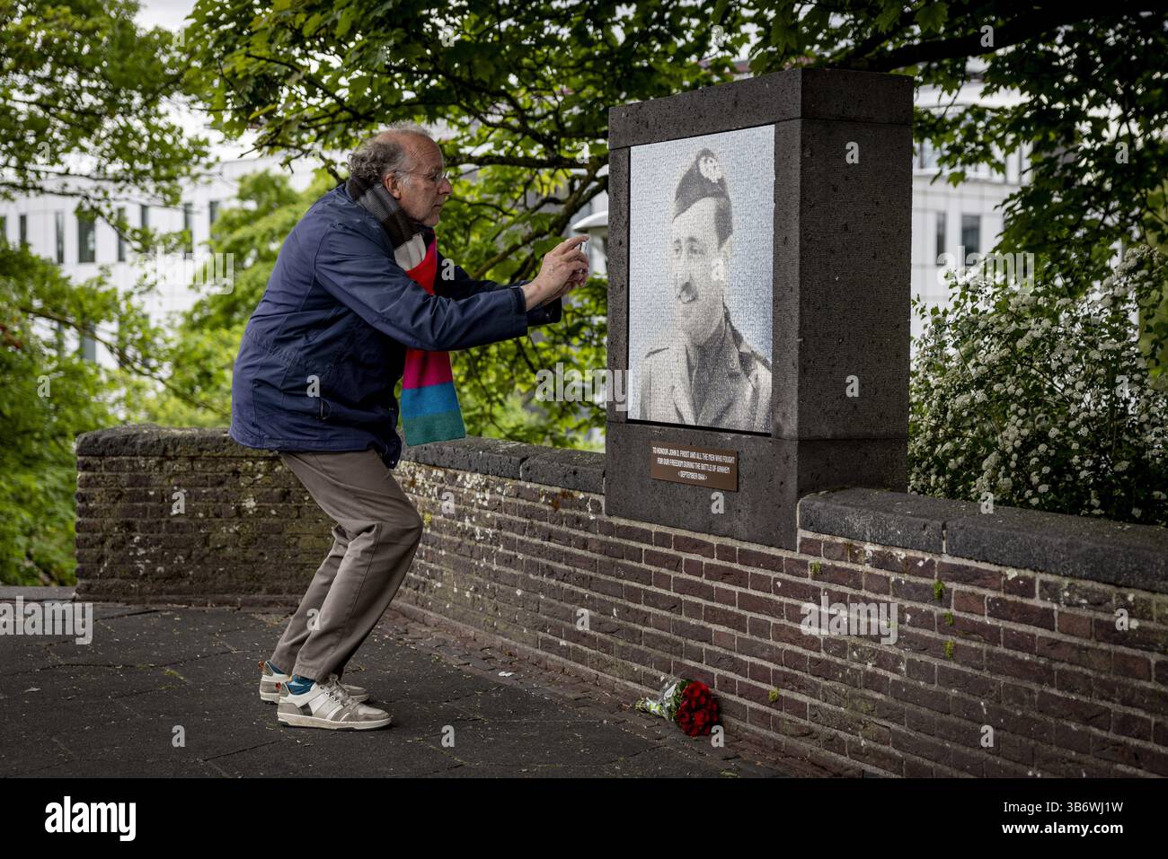 ARNHEM - People look at the new plaque on the monument at the John ...
