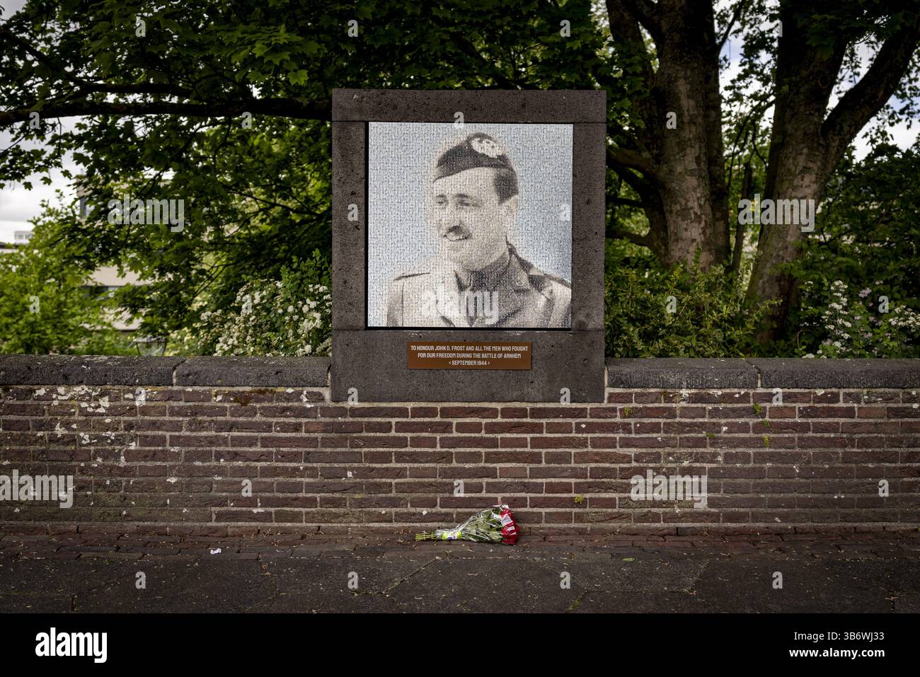 ARNHEM - People look at the new plaque on the monument at the John ...
