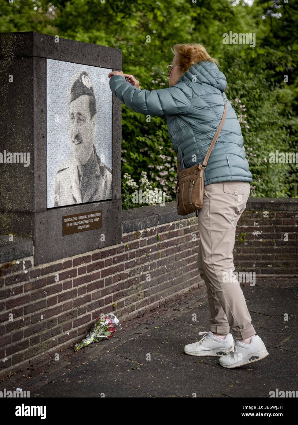 ARNHEM - People look at the new plaque on the monument at the John ...