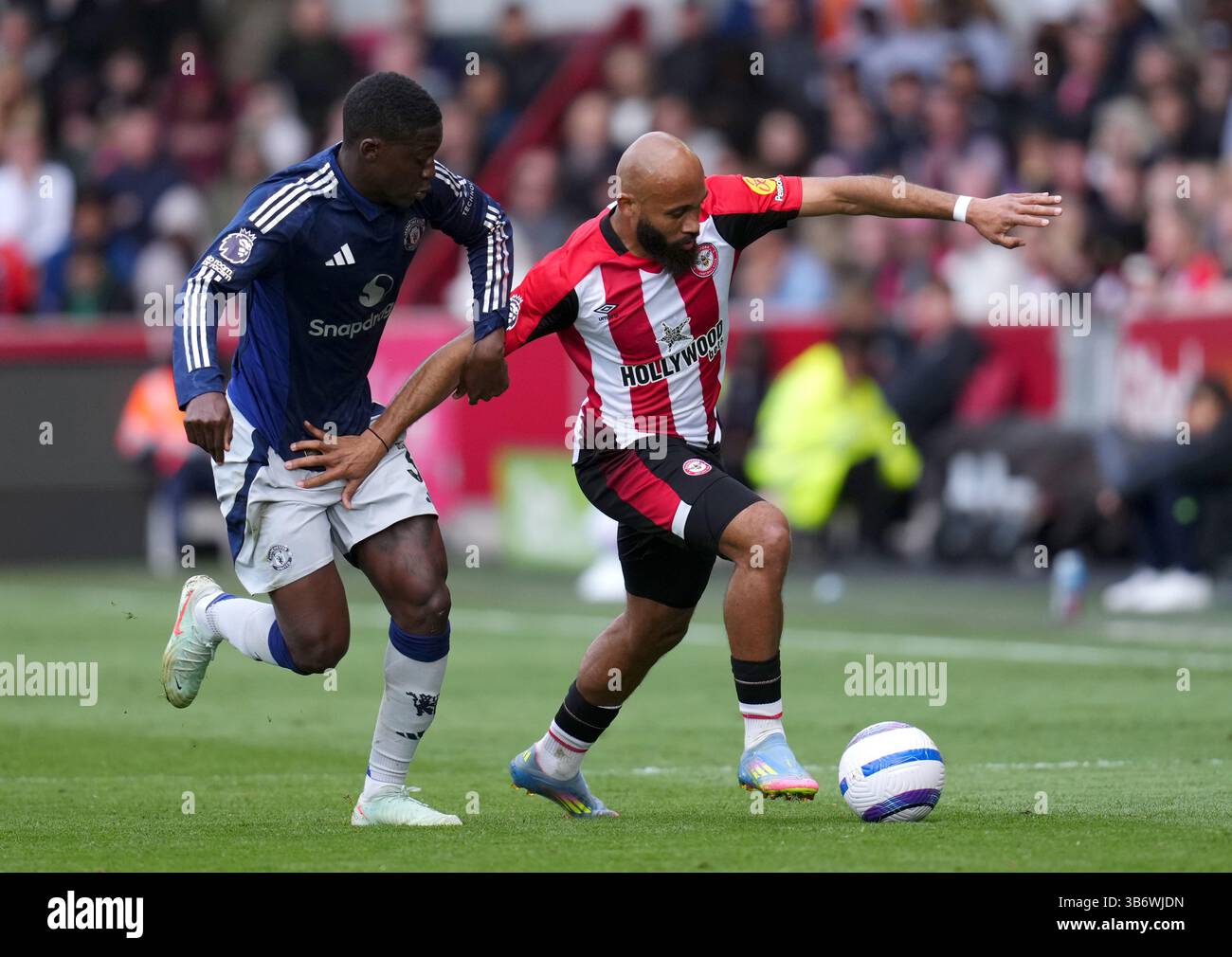 Manchester United's Kobbie Mainoo (left) and Brentford's Bryan Mbeumo ...