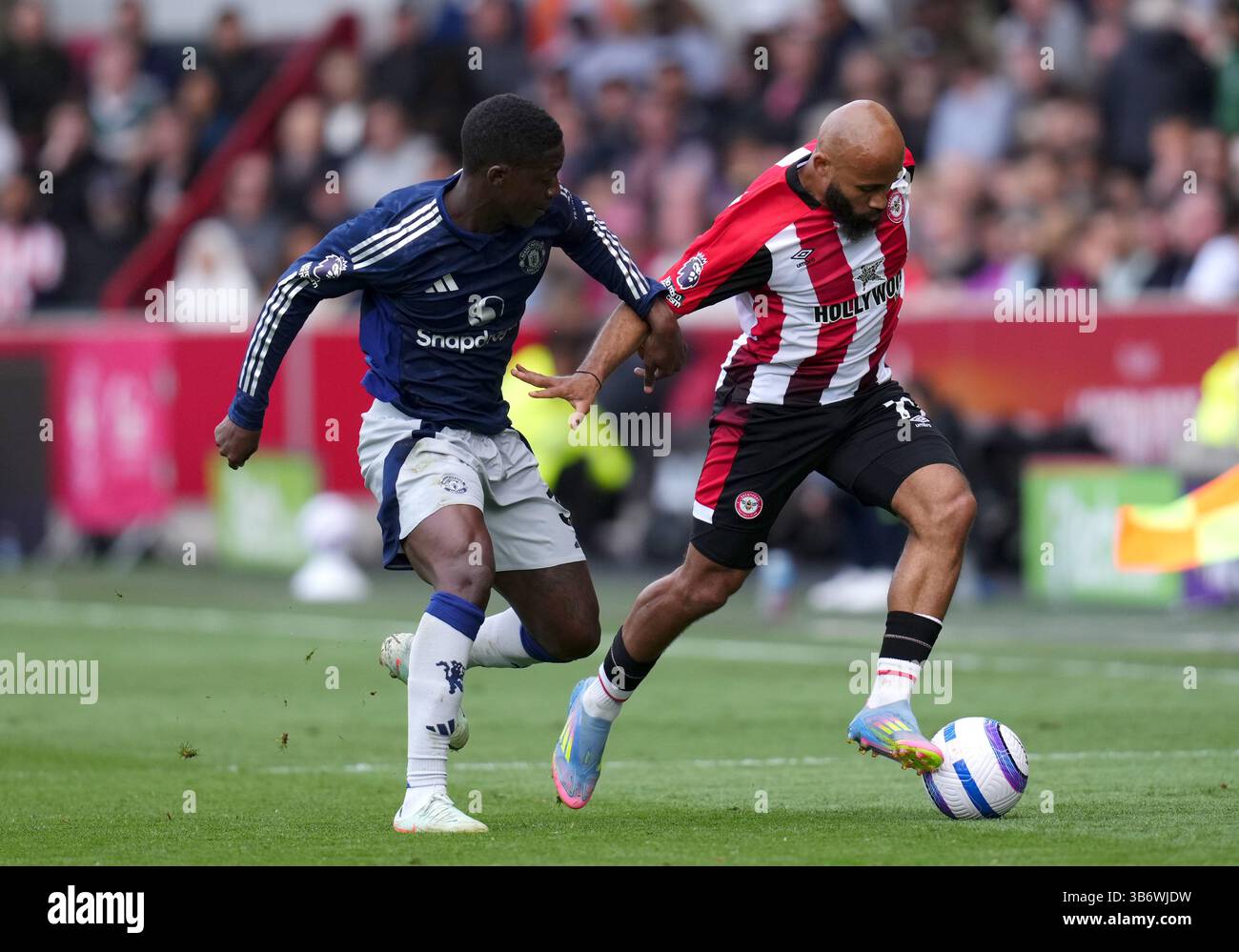 Manchester United's Kobbie Mainoo (left) and Brentford's Bryan Mbeumo ...