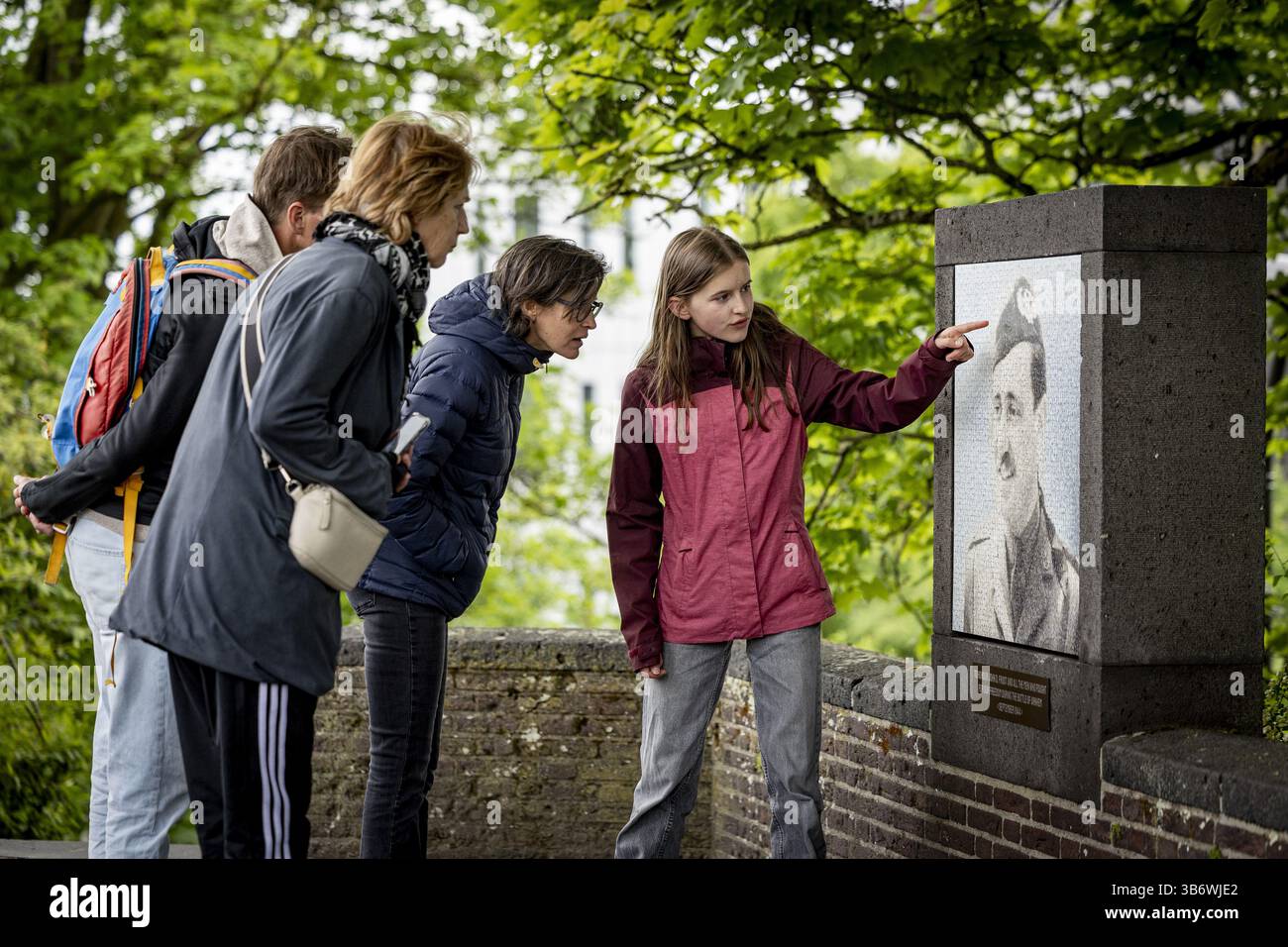 ARNHEM - People look at the new plaque on the monument at the John ...