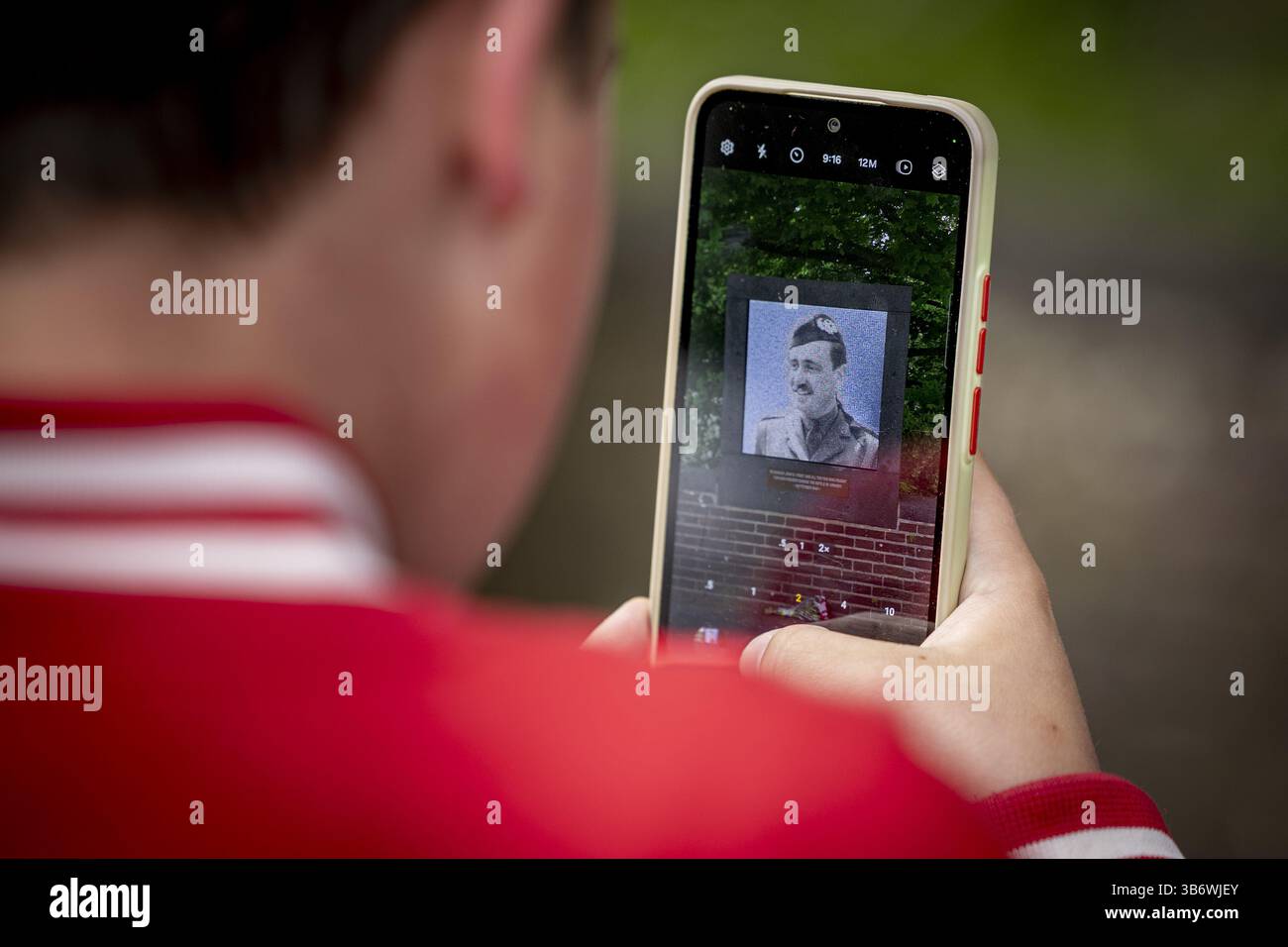 ARNHEM - People look at the new plaque on the monument at the John ...