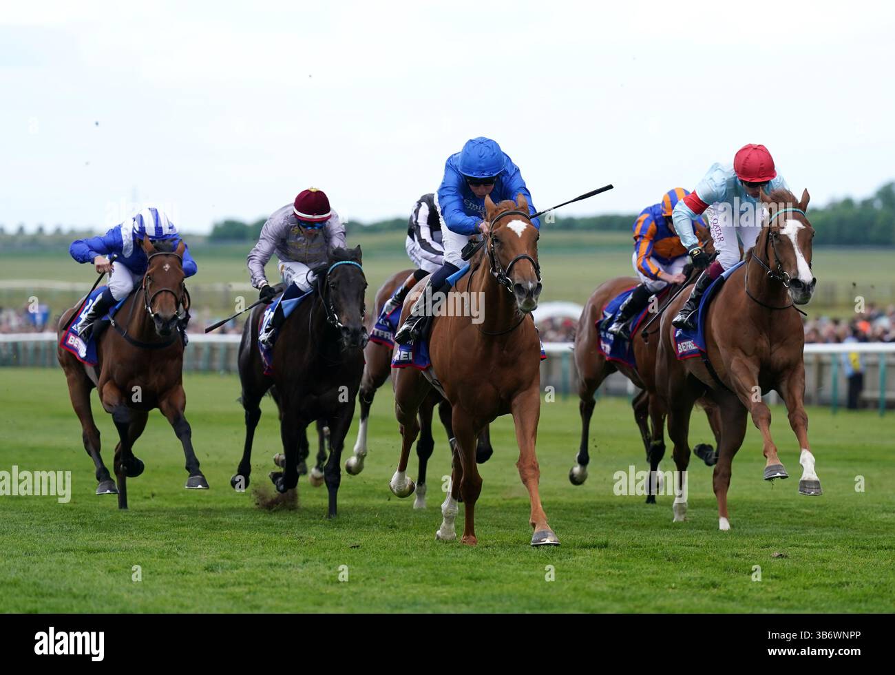Desert Flower ridden by William Buick (centre) on their way to winning ...