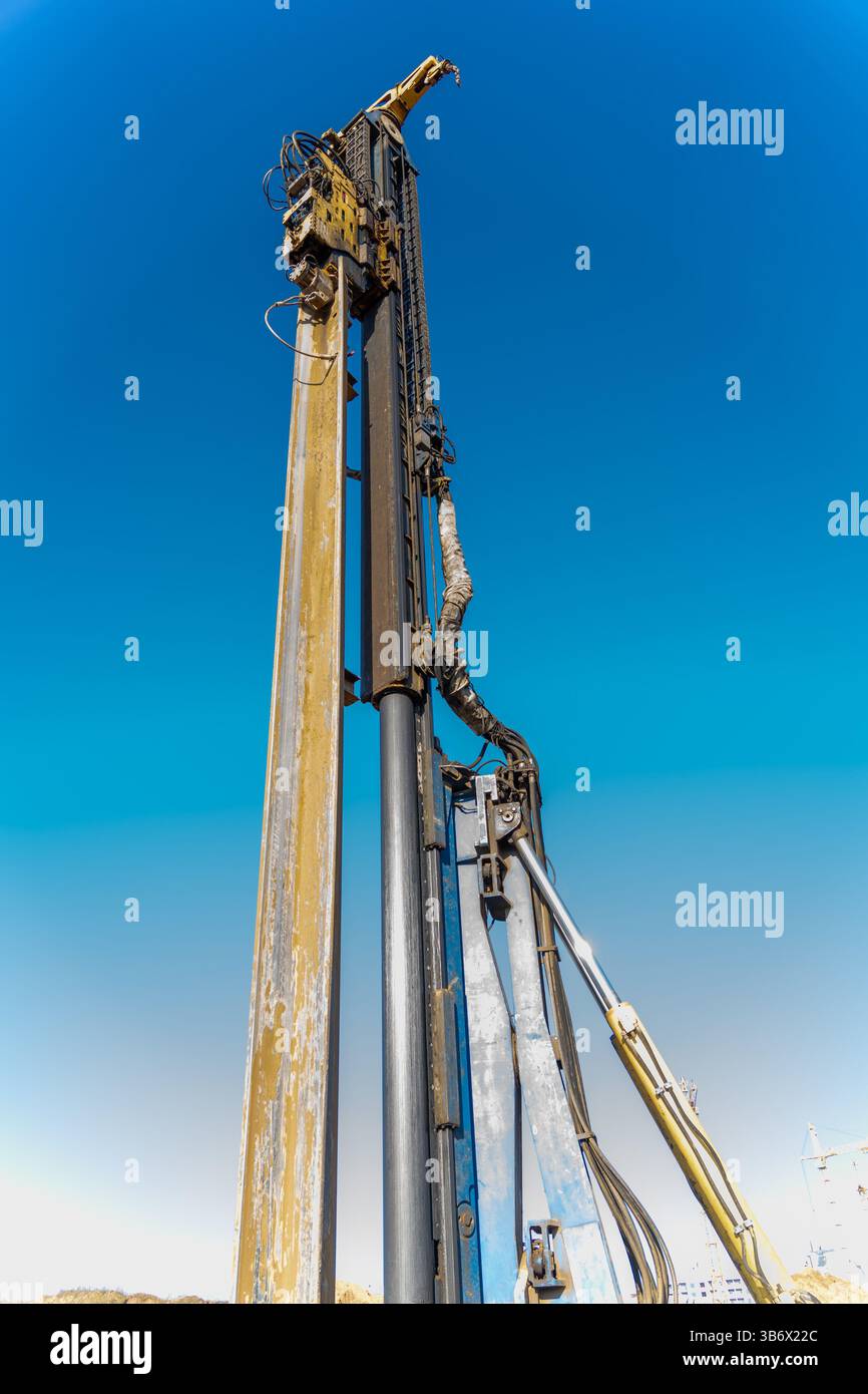 The yellow vibrating piling machine removes Larssen sheet piling from ...