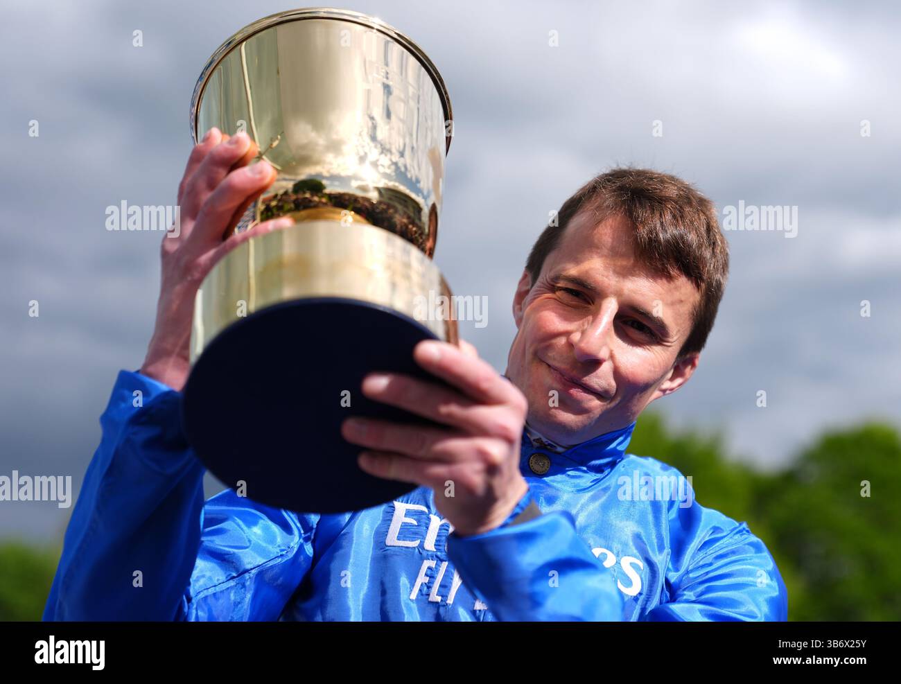 William Buick lifts the trophy after winning the Betfred 1000 Guineas ...