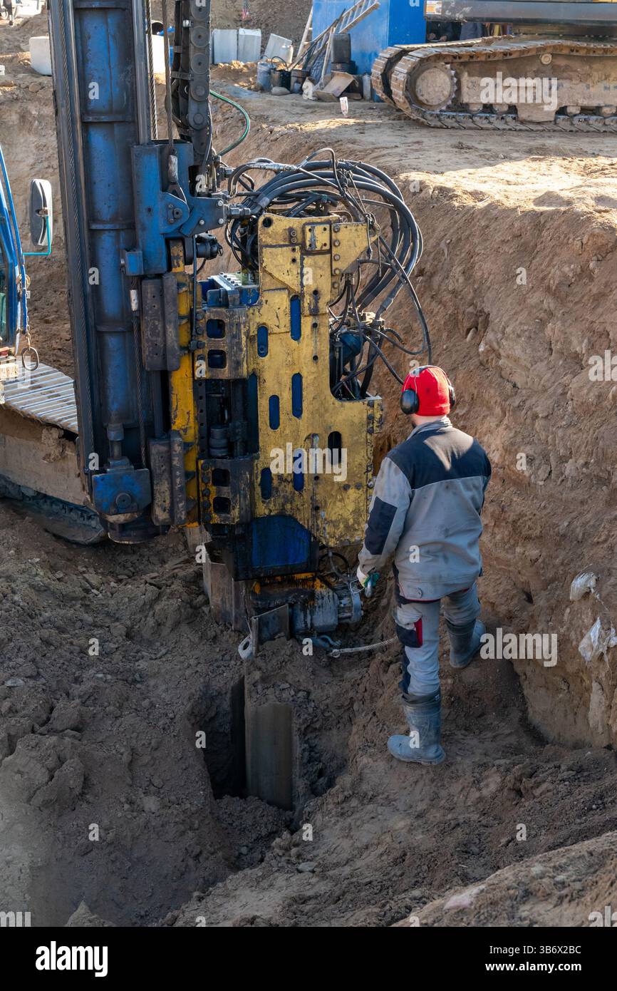 A worker controls the extraction of Larssen sheet piling from the ...