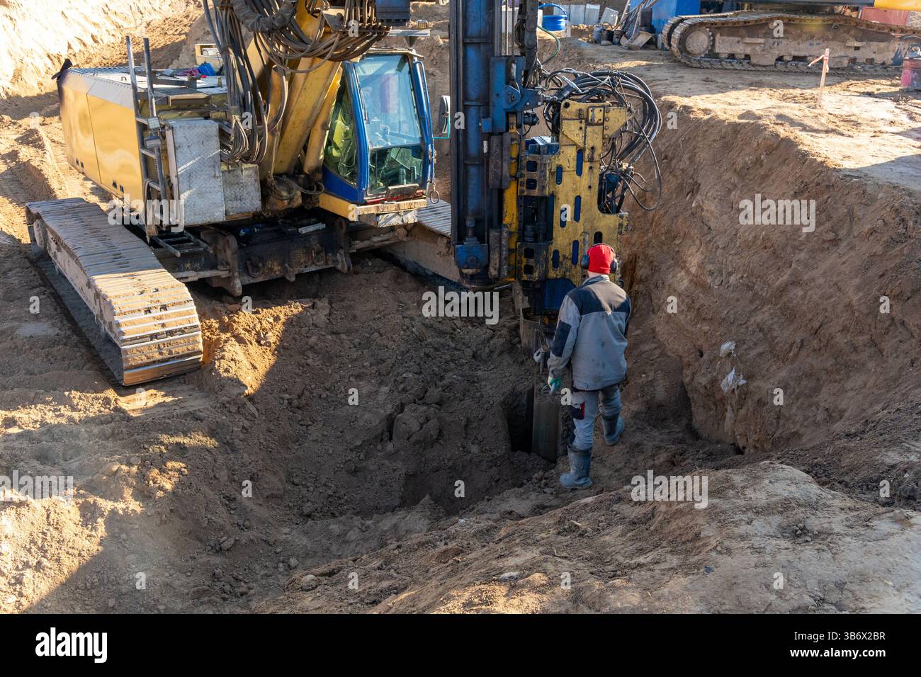 A worker controls the extraction of Larssen sheet piling from the ...