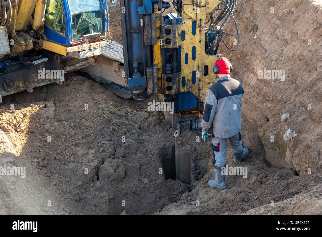 A worker controls the extraction of Larssen sheet piling from the ...