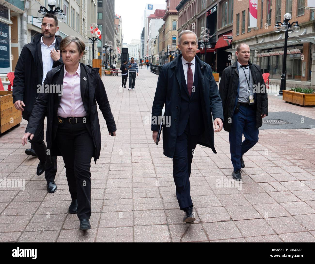 Prime Minister Mark Carney walks to his first news conference after ...