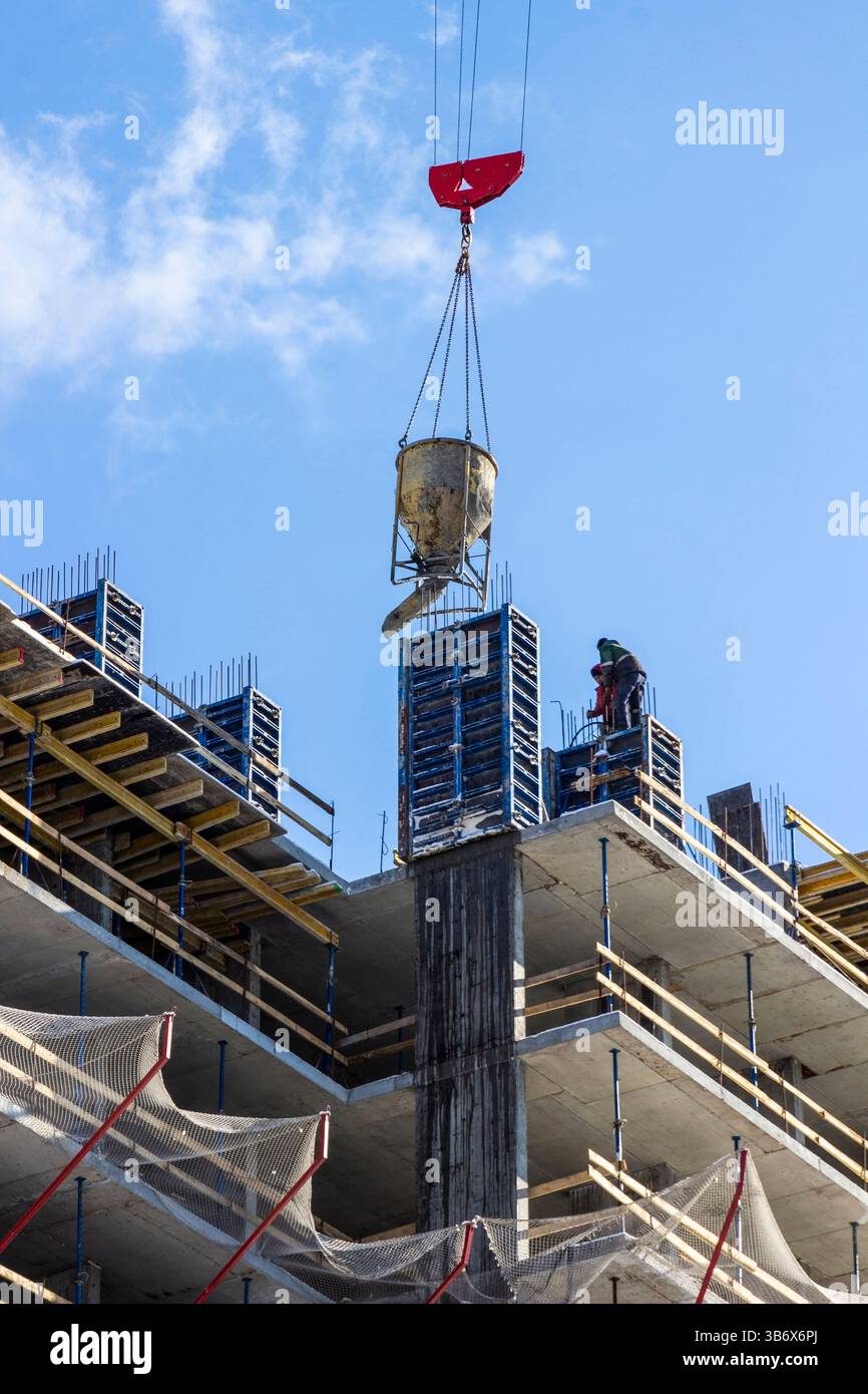 House construction: reinforced concrete floors, a crane delivers ...