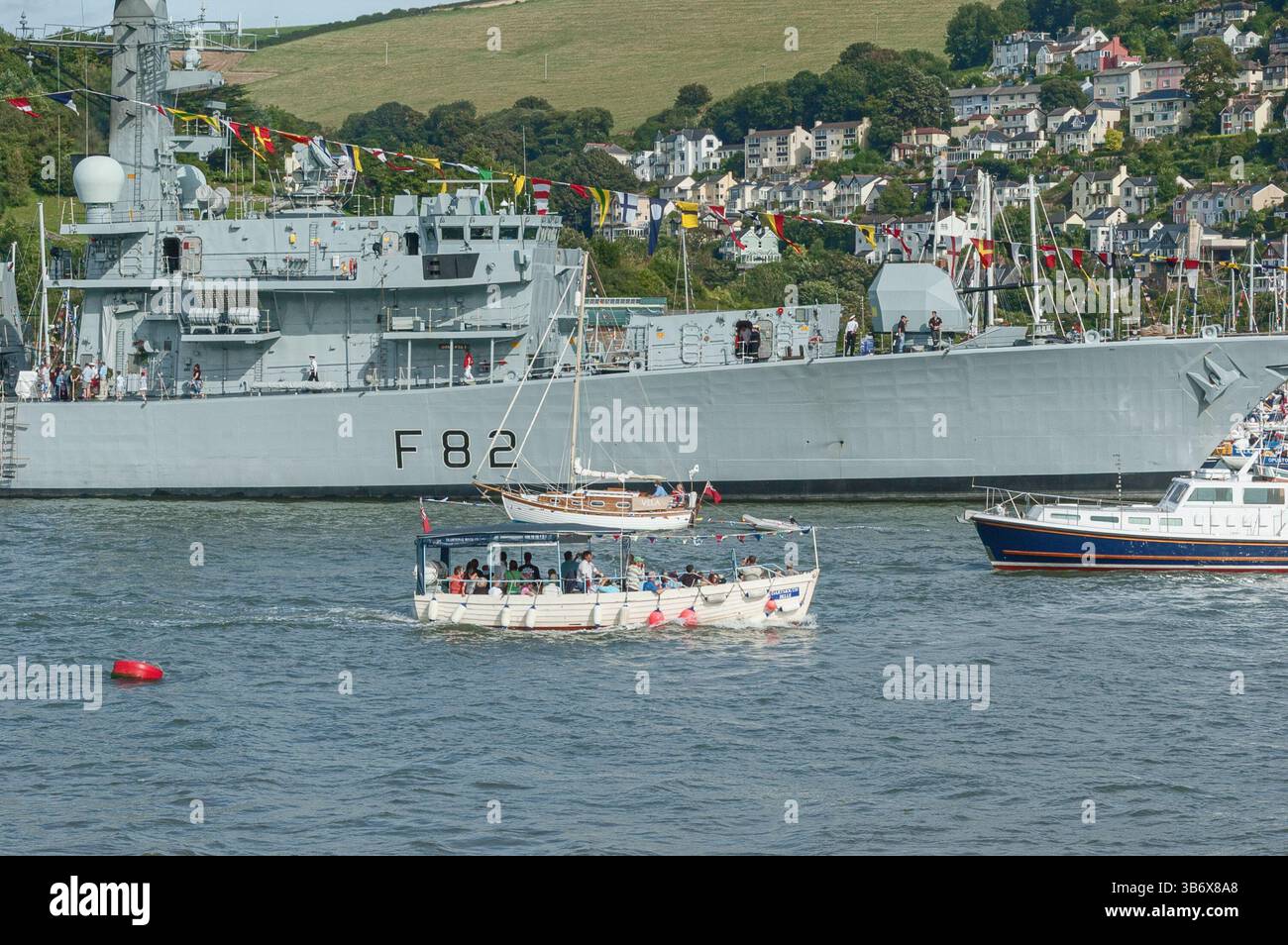Passenger boats with tourists sail past HMS Somerset on Royal Navy Day ...