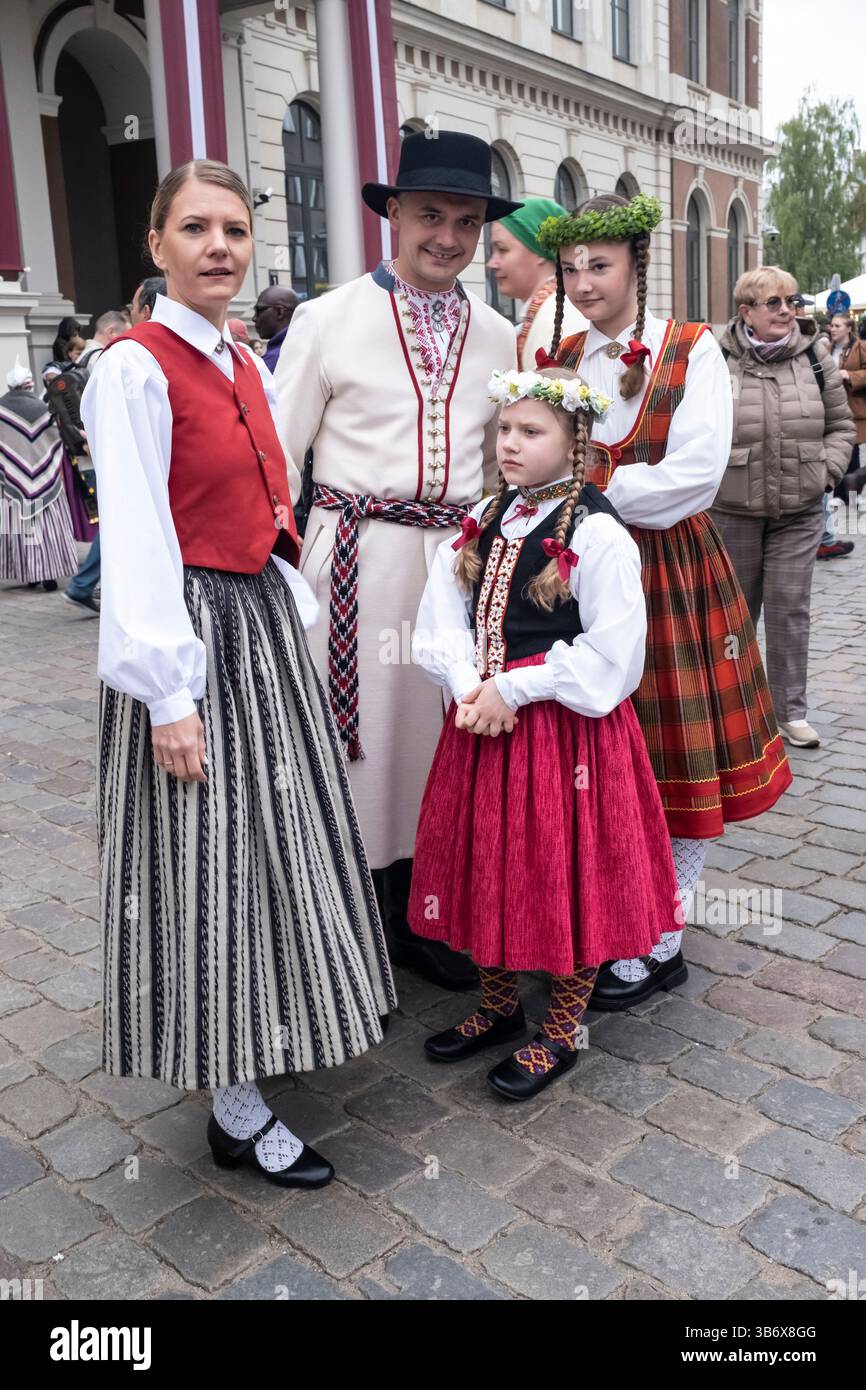 Family in national costumes with flower wreaths at 4th May celebration ...