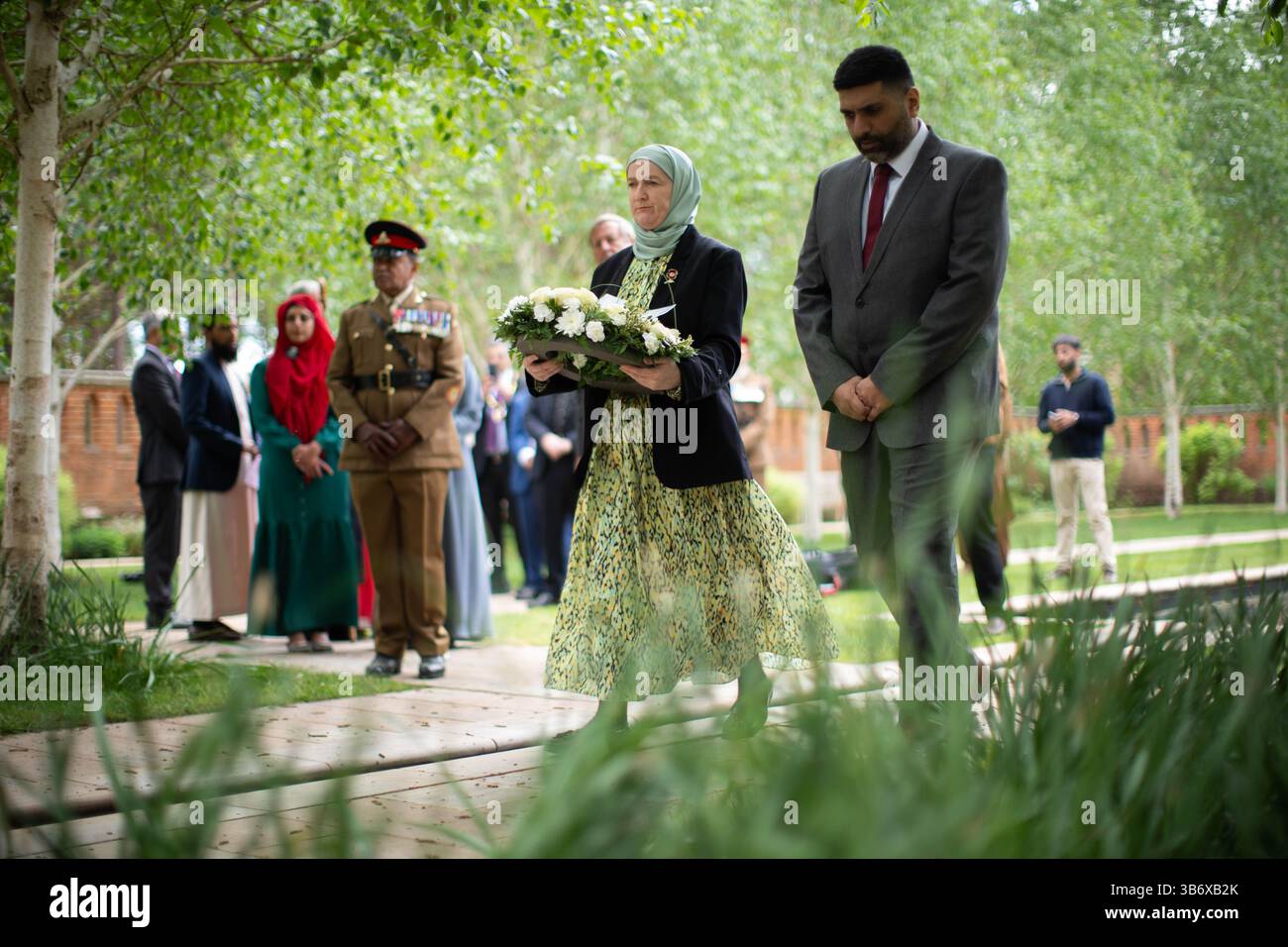 A person holding a wreath in the Peace Garden in Woking, ahead of a VE ...