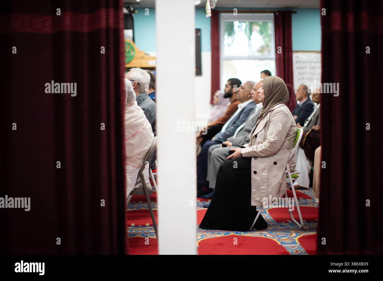 Members of the Muslim community listen to speeches ahead of a VE Day ...