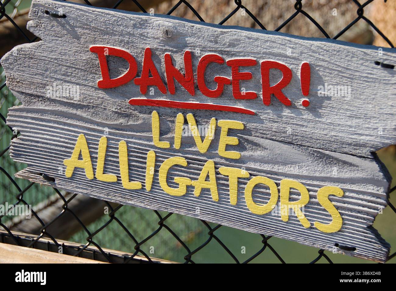 Warning sign at an alligator enclosure reads "Danger! Live Alligators ...