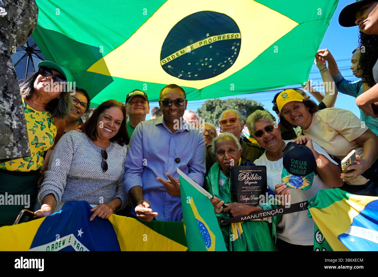 Supporters of former President Jair Bolsonaro pose for a photo in front of the hospital, before ...