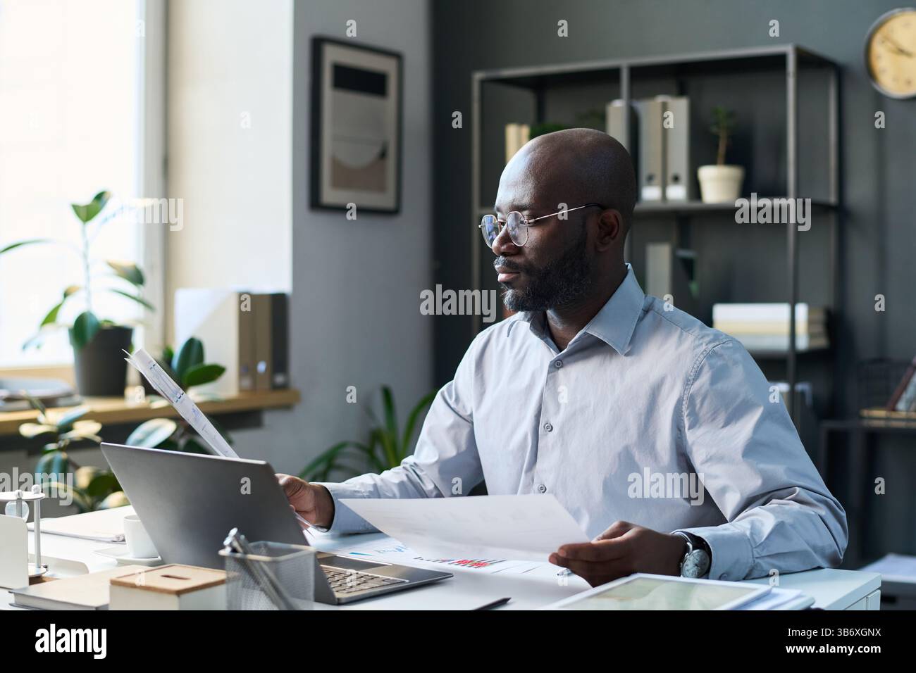 Man looking at business graphs hi-res stock photography and images - Alamy
