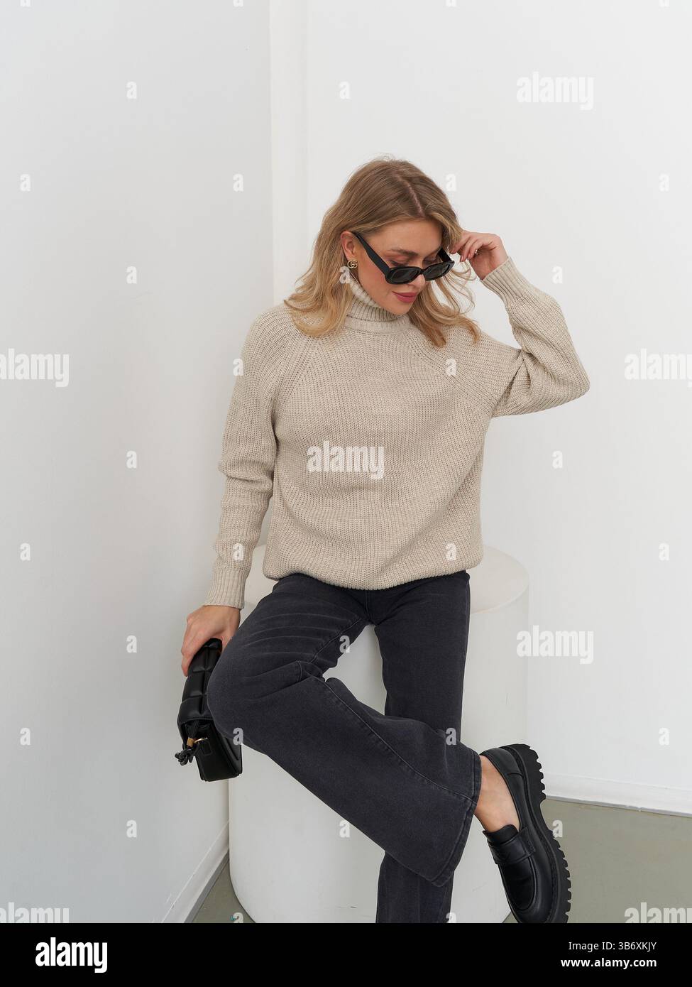 Elegant female model showcases fashion trends in a stylish studio ...