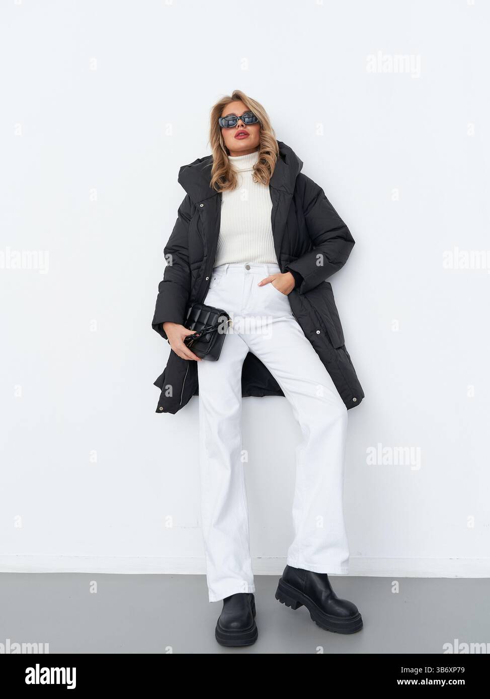 Stylish female model showcases modern fashion looks in a studio setting ...