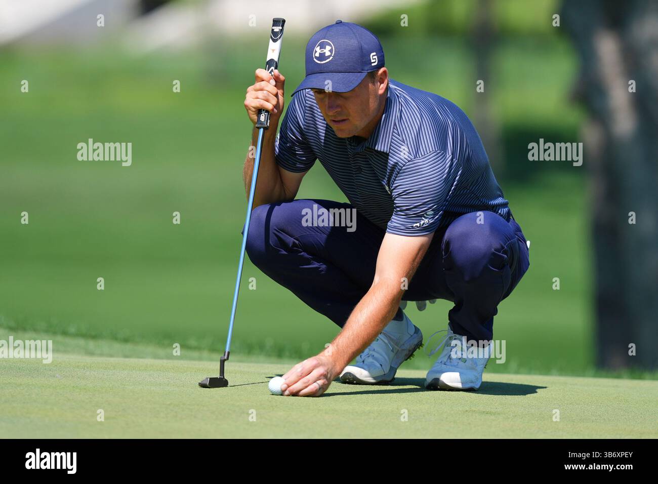 Jordan Spieth sets up for a putt on the first green during the final ...