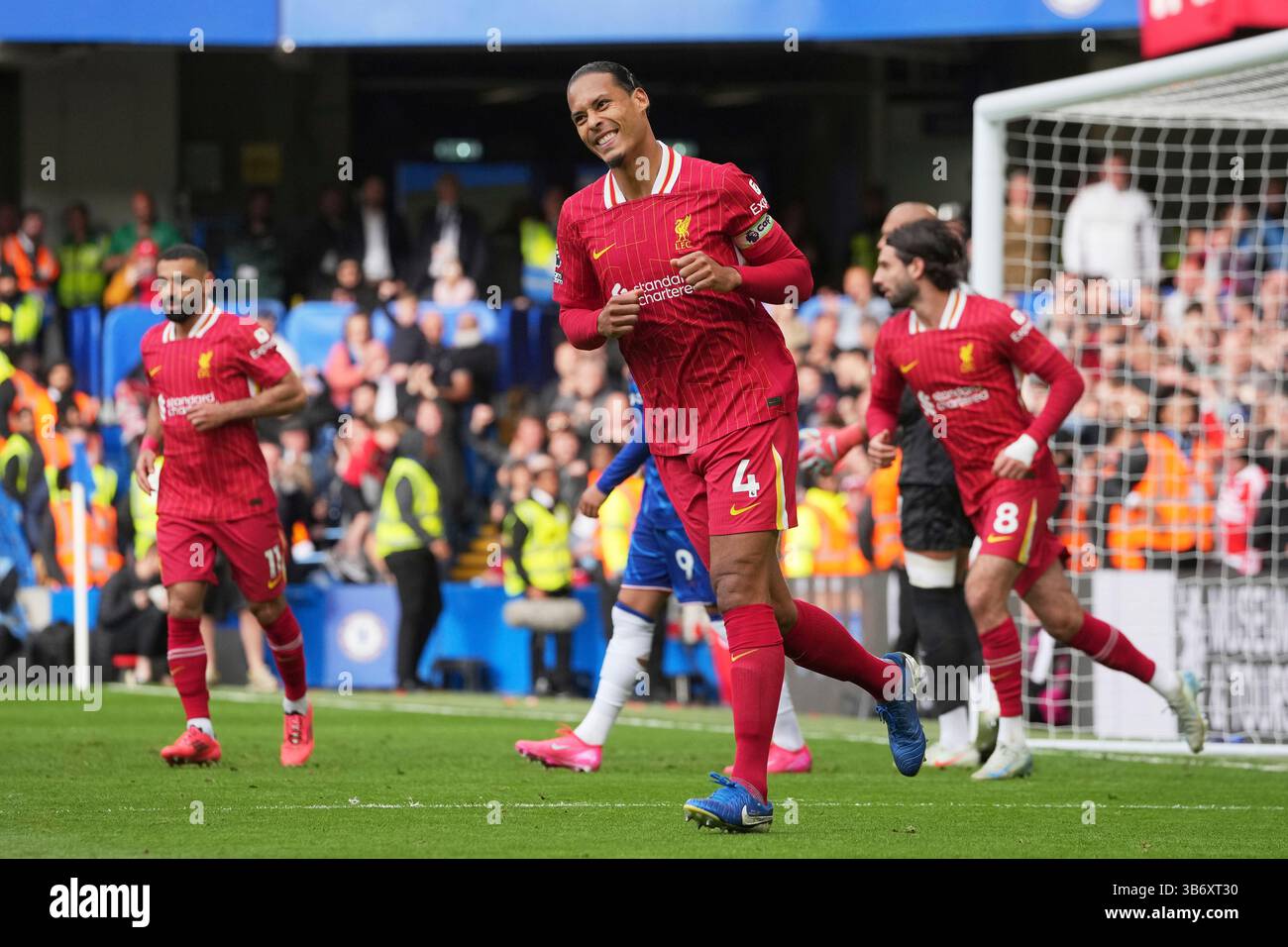 Liverpool's Virgil van Dijk celebrates scoring his side's first goal ...