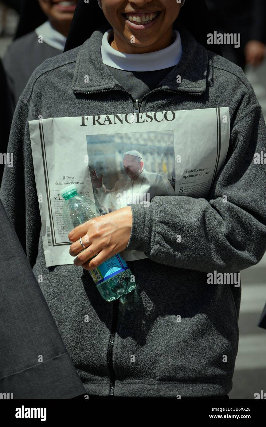Rome, Italy. 26th Apr, 2025. A Bridgettine nun is seen with a newspaper ...