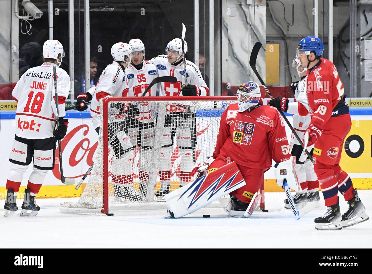 Switzerland's Sven Jung, left, joins teammates, Simon Knak goal scorer ...