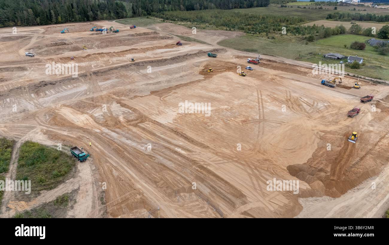 Aerial view of a large construction site with heavy machinery and ...