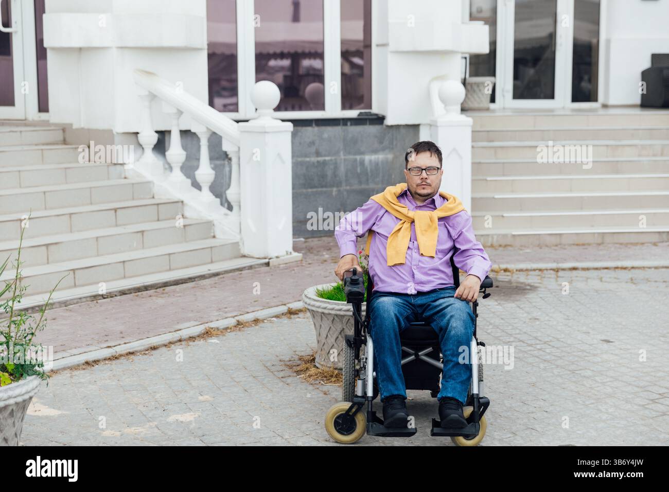 A man in a wheelchair is resting on a walk through the streets Stock ...