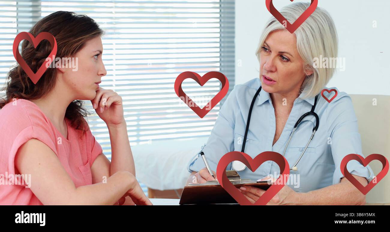 Image of hearts falling over caucasian female doctor talking with ...