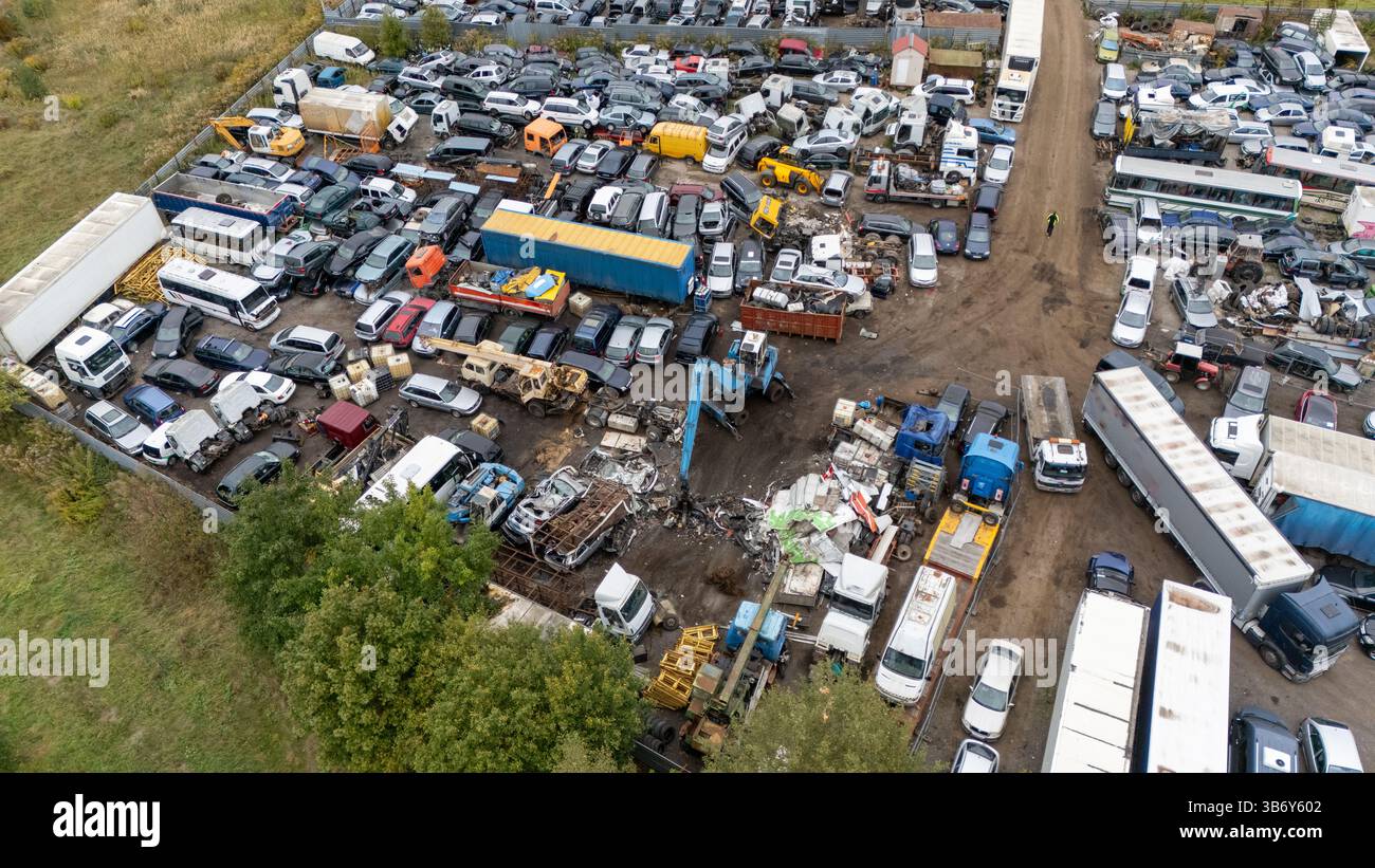 Aerial view of a crowded junkyard with numerous cars, trucks, and scrap ...