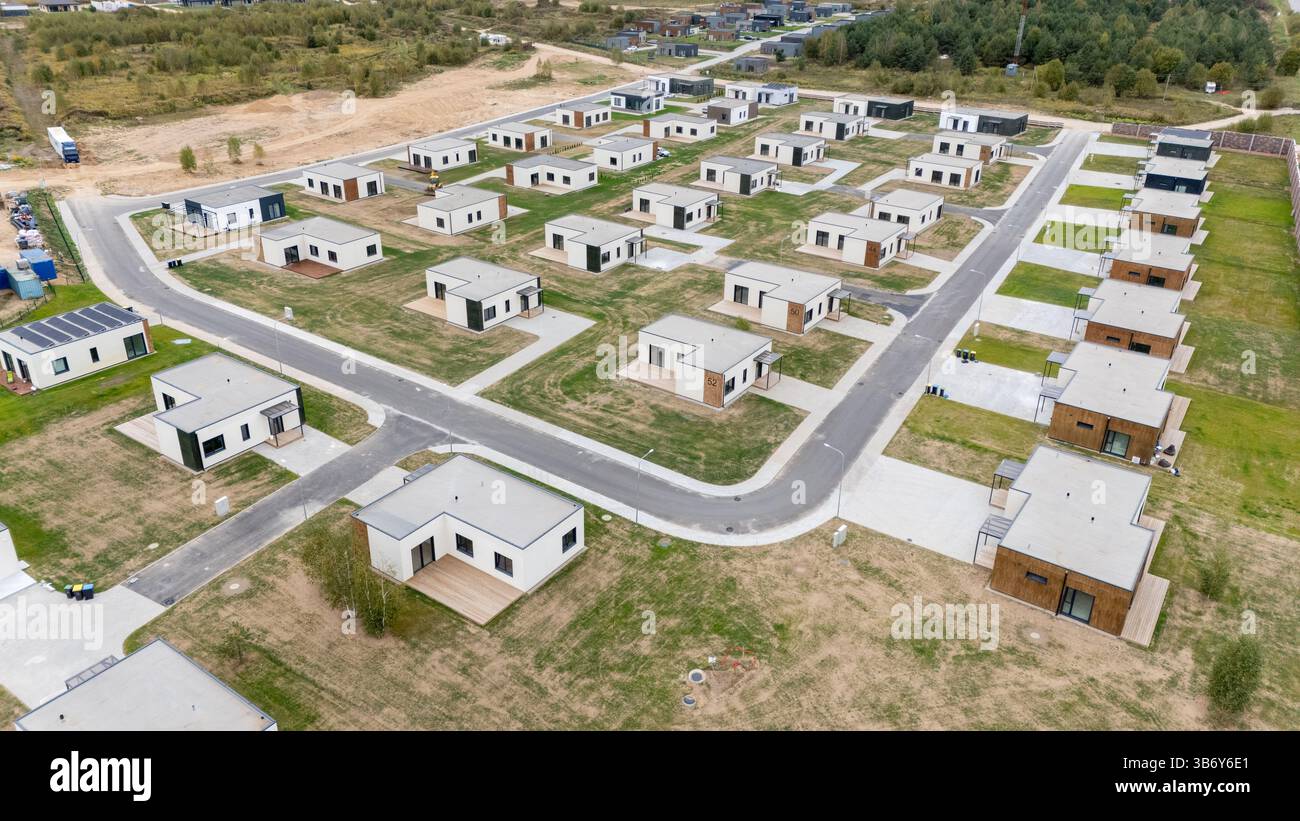Aerial view of a modern suburban neighborhood with identical single ...