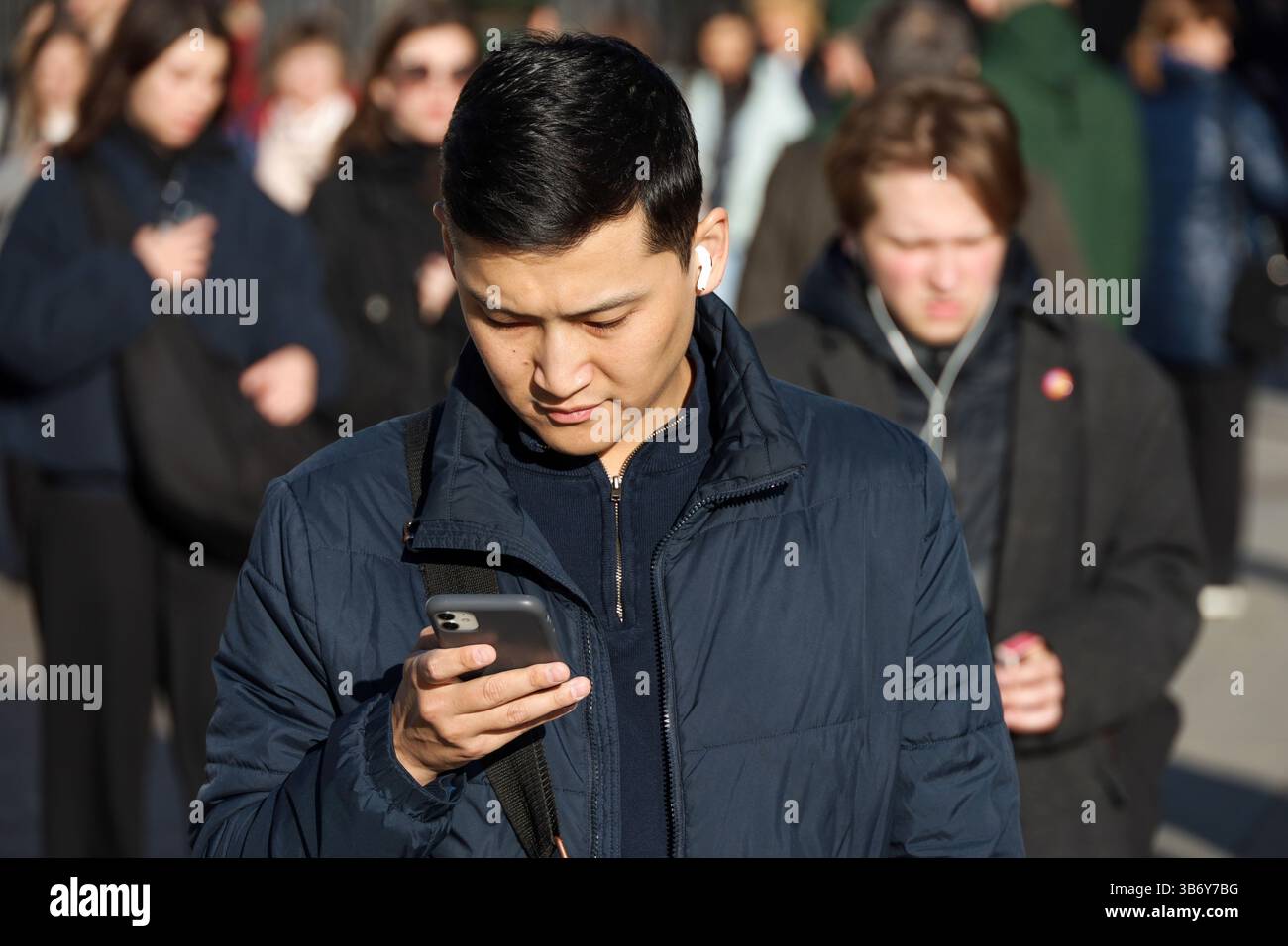 Phone call looking in crowd hi-res stock photography and images - Alamy
