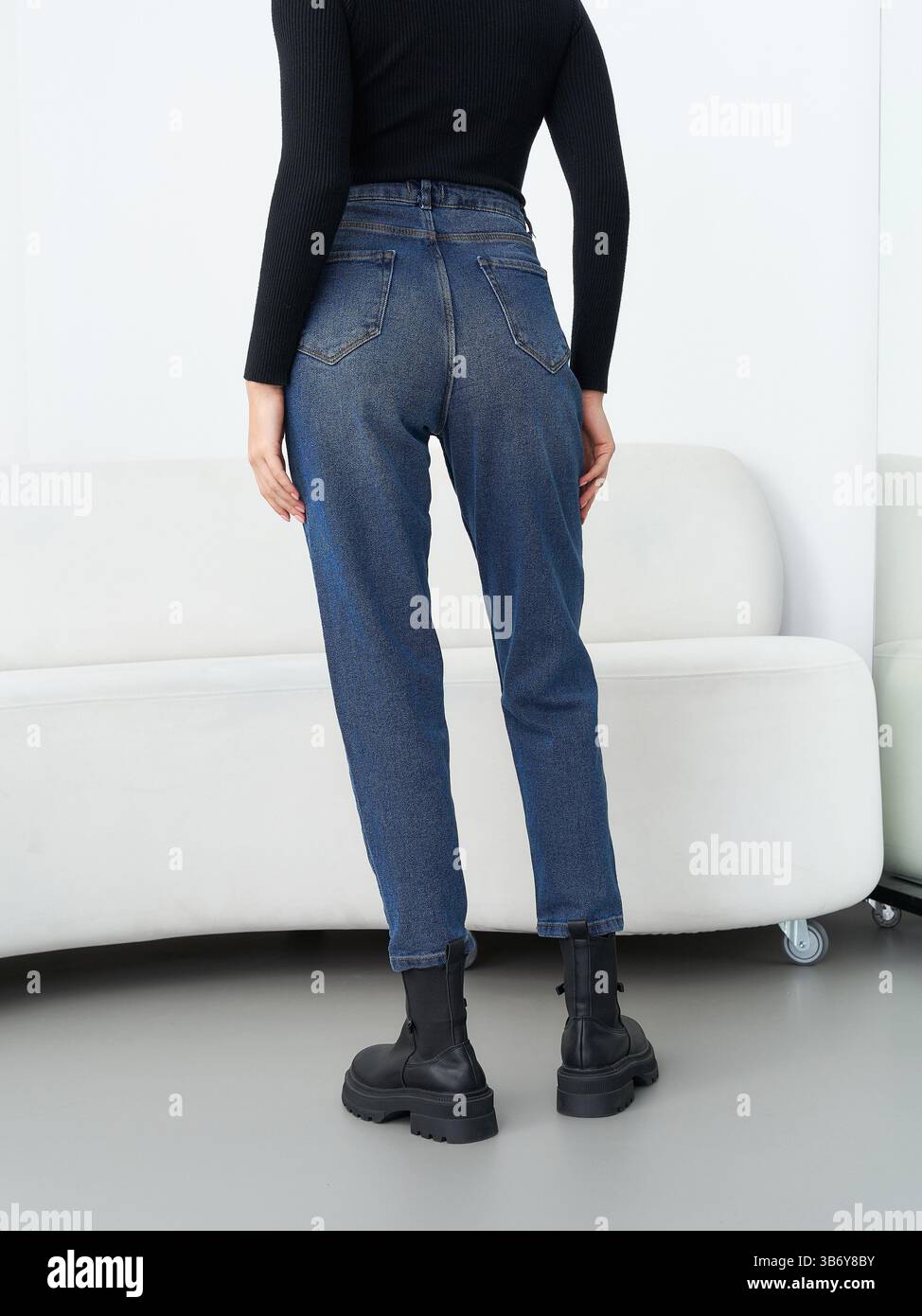 Elegant female model showcases fashion in stylish denim ensemble at ...