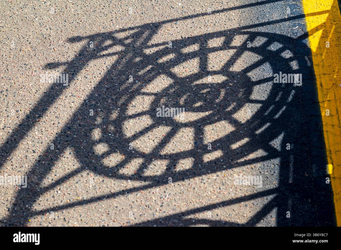 Shadow casting from the metal decorative fence to the asphalt Stock ...