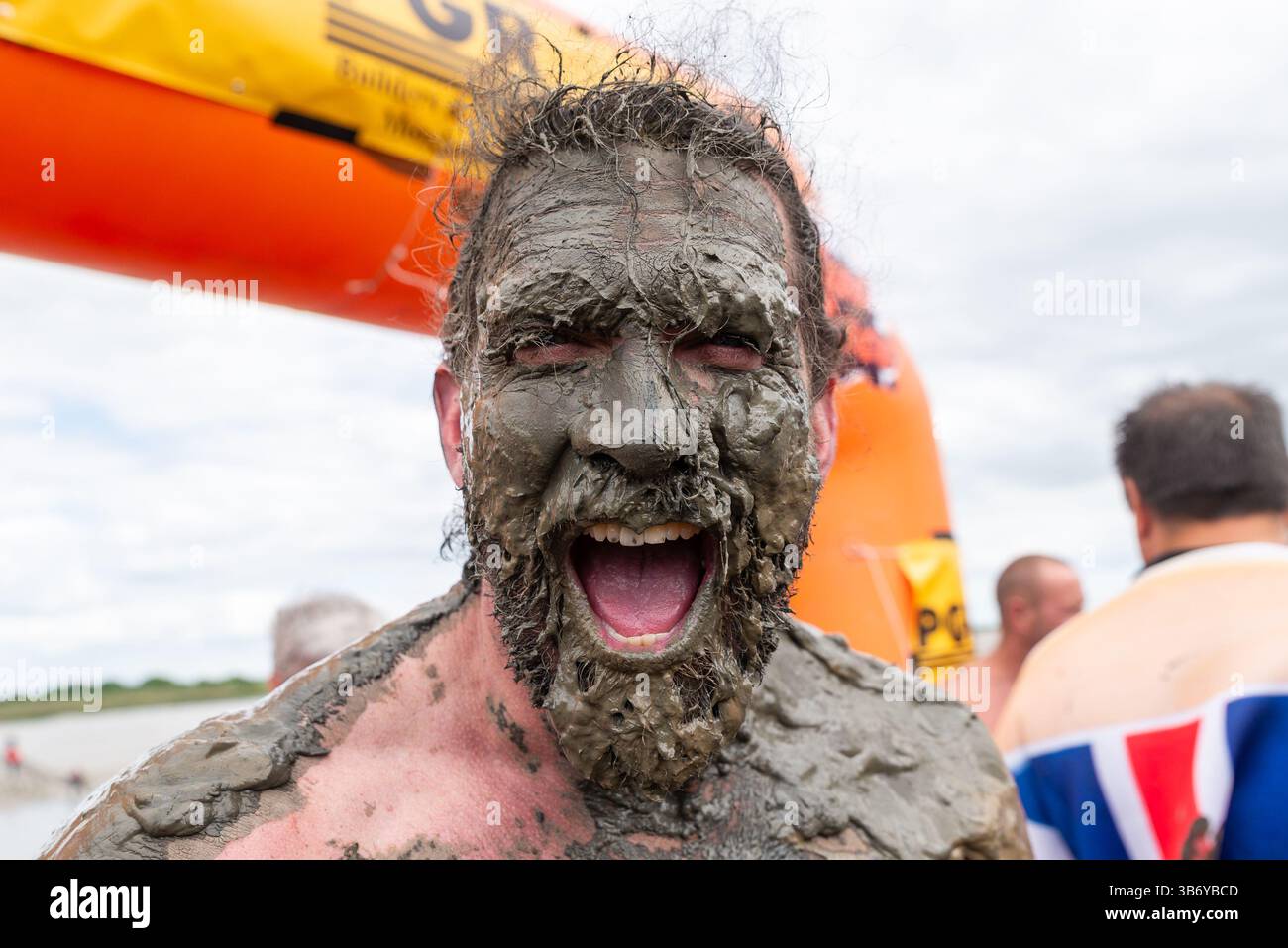 Maldon Mud Race 2025. Participant Joel Hicks with muddy face at the ...