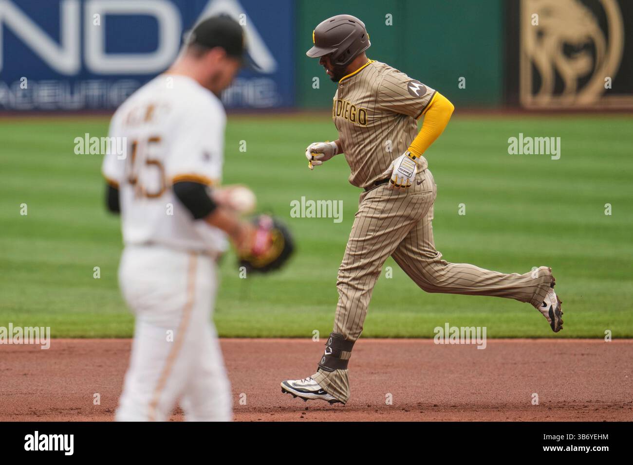 San Diego Padres' Elias Díaz, right, rounds the bases after hitting a ...
