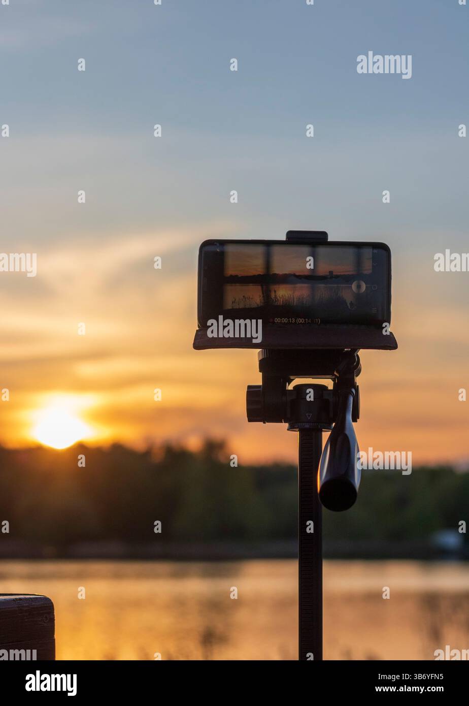 Cell phone on the tripod capturing sun set moment Stock Photo - Alamy