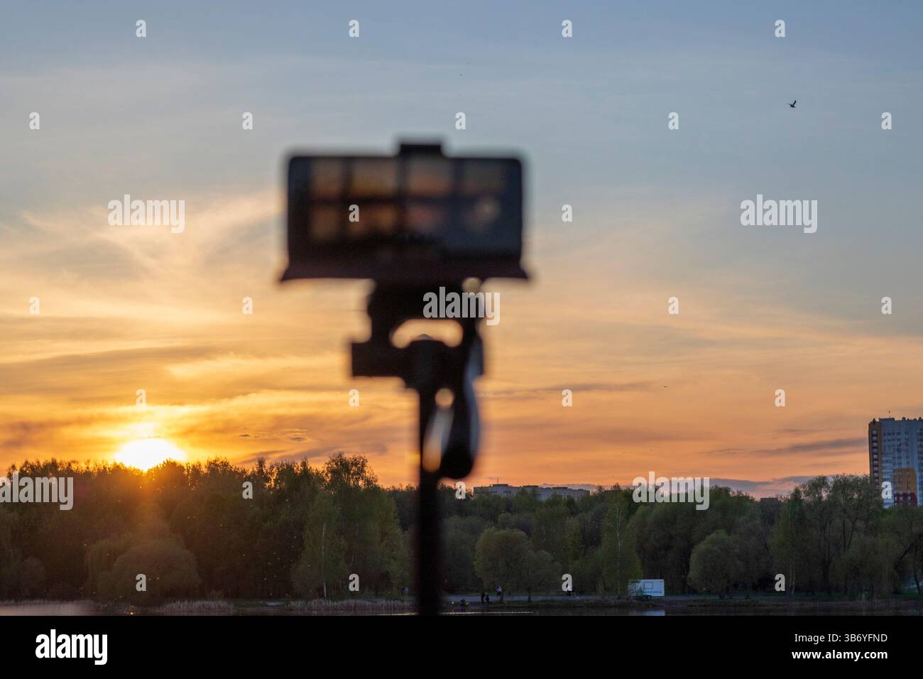 Cell phone on the tripod capturing sun set moment Stock Photo - Alamy
