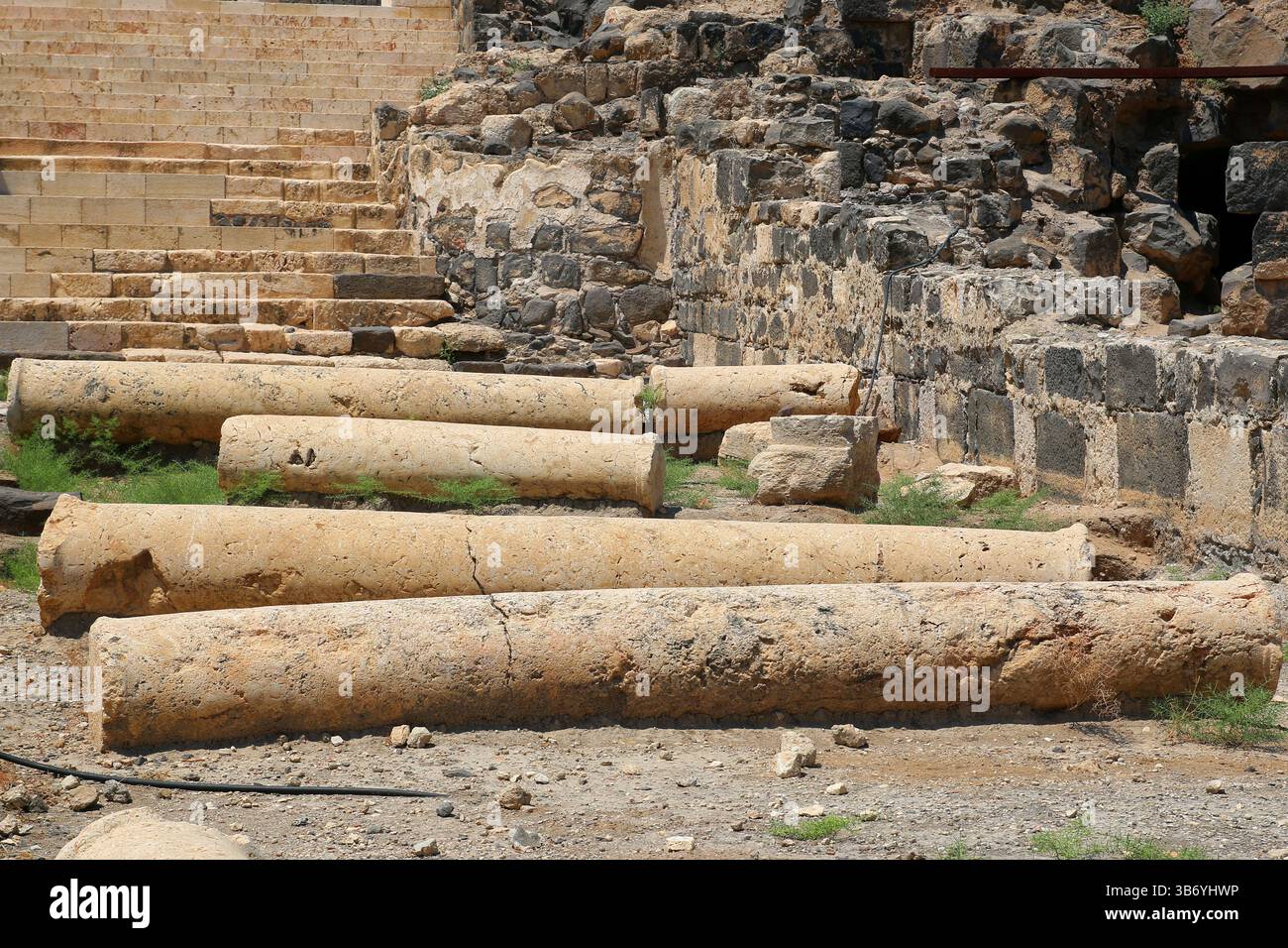 Collapsed Roman columns among ruins in the archaeological site of Beit ...