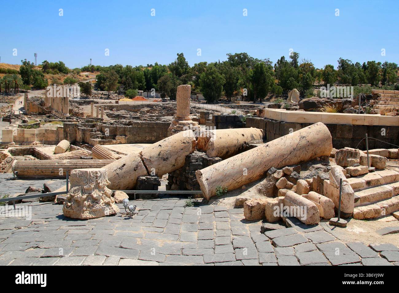 Collapsed Roman columns among ruins in the archaeological site of Beit ...