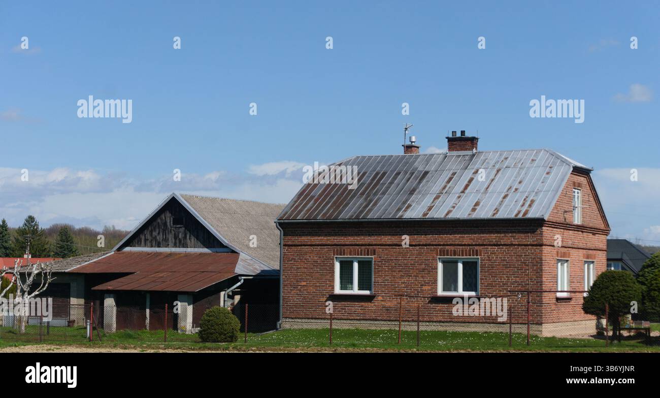 Brick house metal roof hi-res stock photography and images - Alamy