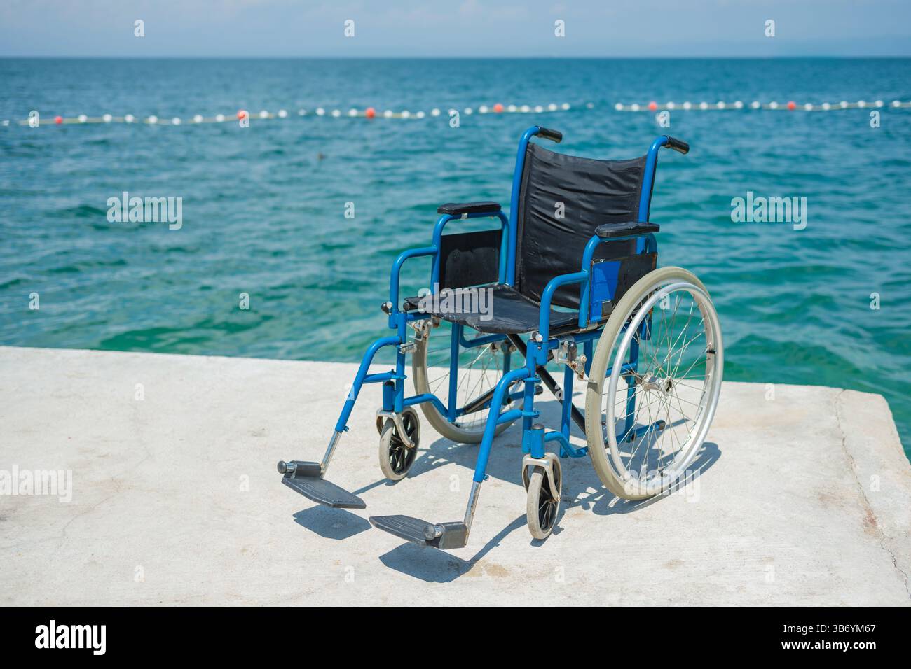 Empty blue steel wheelchair, for people with disabilities, placed on ...